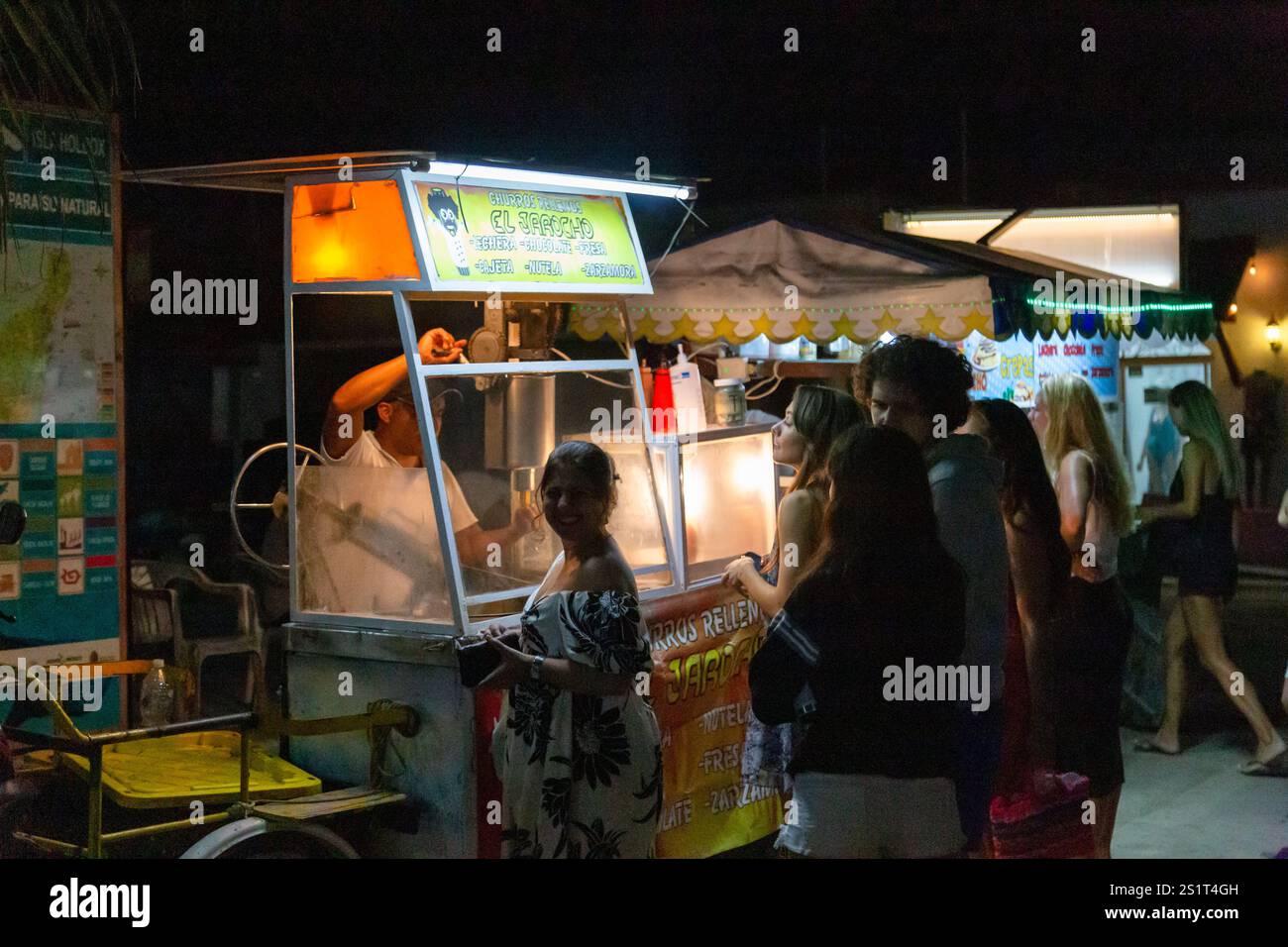 People Enjoy Street Food at An Outdoor Vendor Stall at Night, Isla ...
