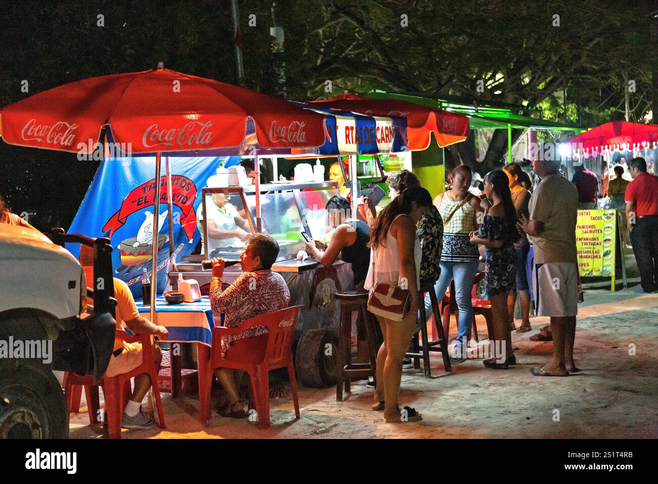 People Enjoy Street Food at An Outdoor Vendor Stall at Night, Isla ...