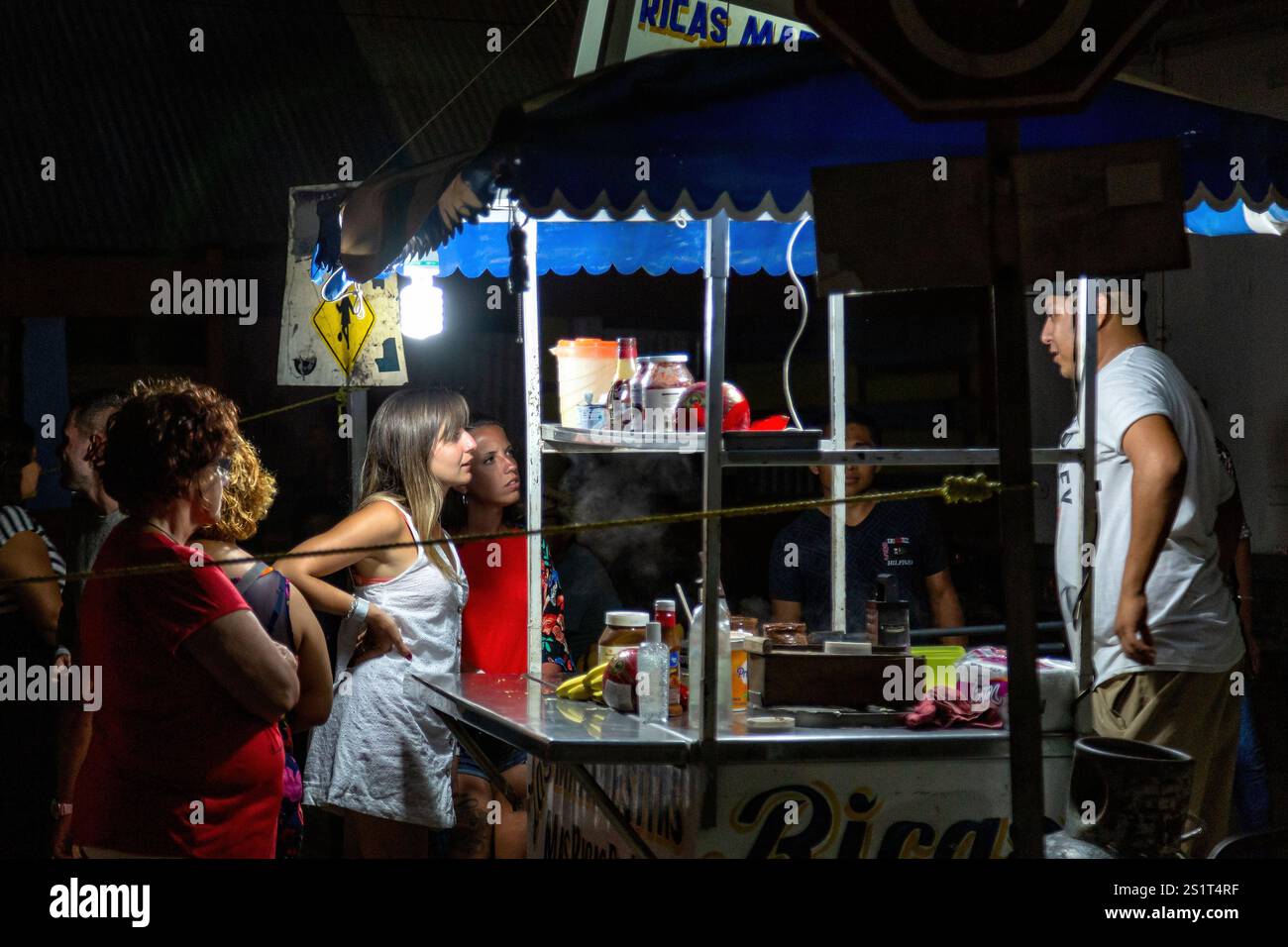 People Enjoy Street Food at An Outdoor Vendor Stall at Night, Isla ...
