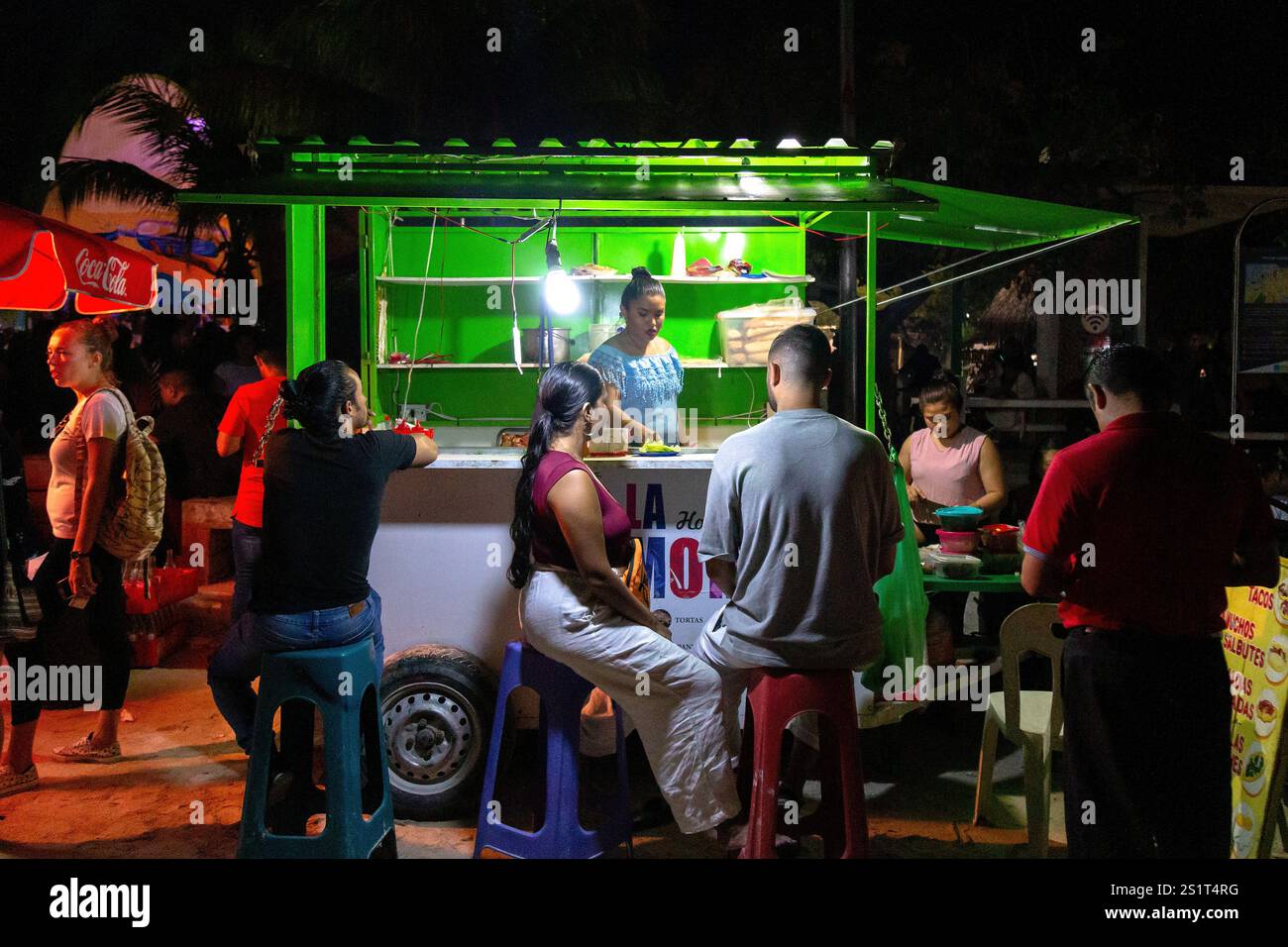 People Enjoy Street Food at An Outdoor Vendor Stall at Night, Isla ...