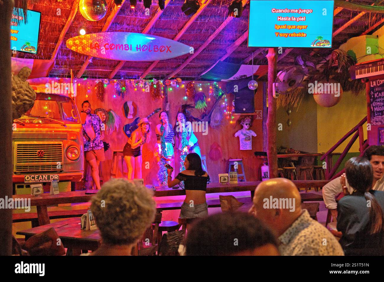 Colorful Karaoke Party Scene in a Vibrant Tropical Themed Bar with Live ...
