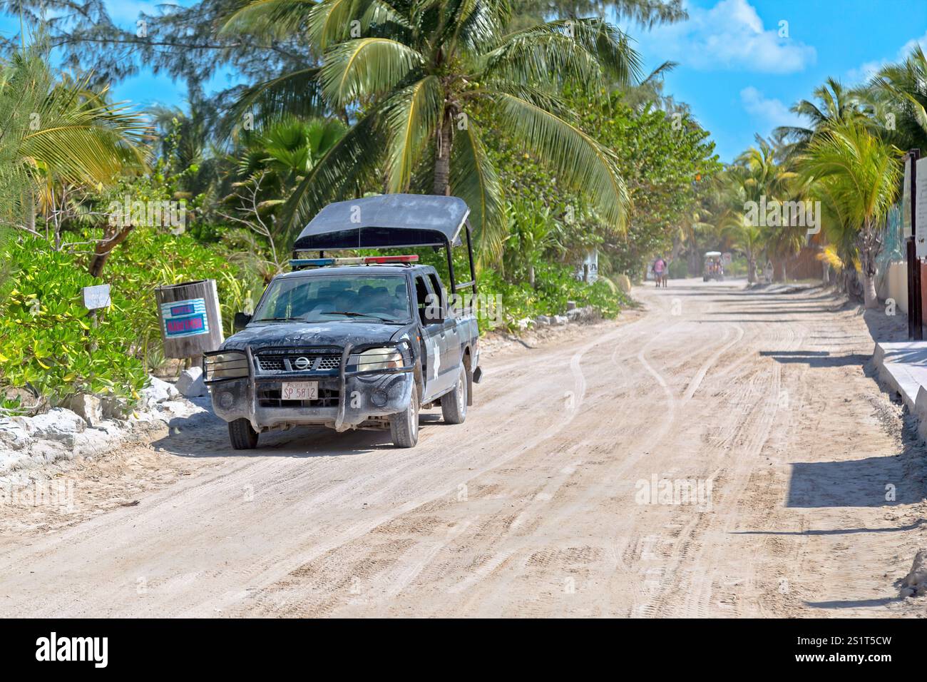 Off-Road Police Vehicle on a Dirt Road Surrounded by Tropical Palm ...