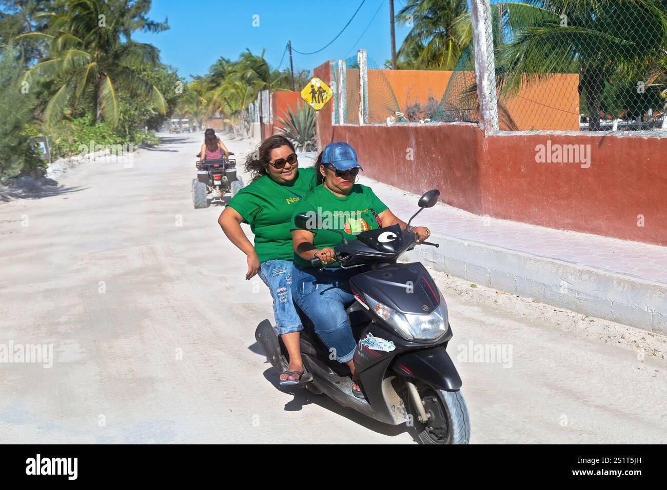 Two People Riding a Scooter on a Sunny Day Near Palm Trees, Isla Holbox ...