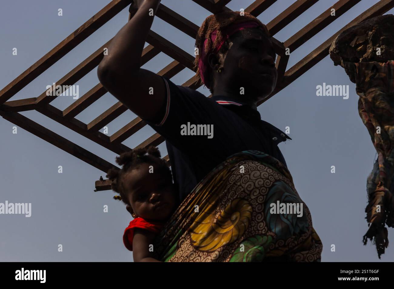 Accra, Accra, Ghana. 4th Jan, 2025. Woman carries burnt pans on her ...