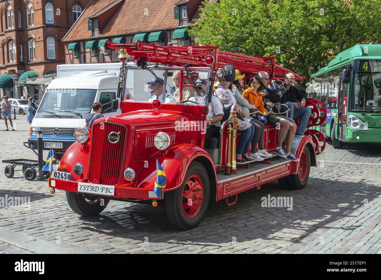 Tourists are guided around the old districts of Ystad with an old fire ...