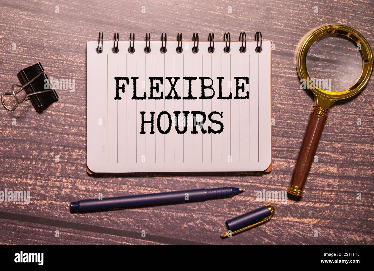 Text FLEXIBLE HOURS on white paper on clipboard with chart and ...