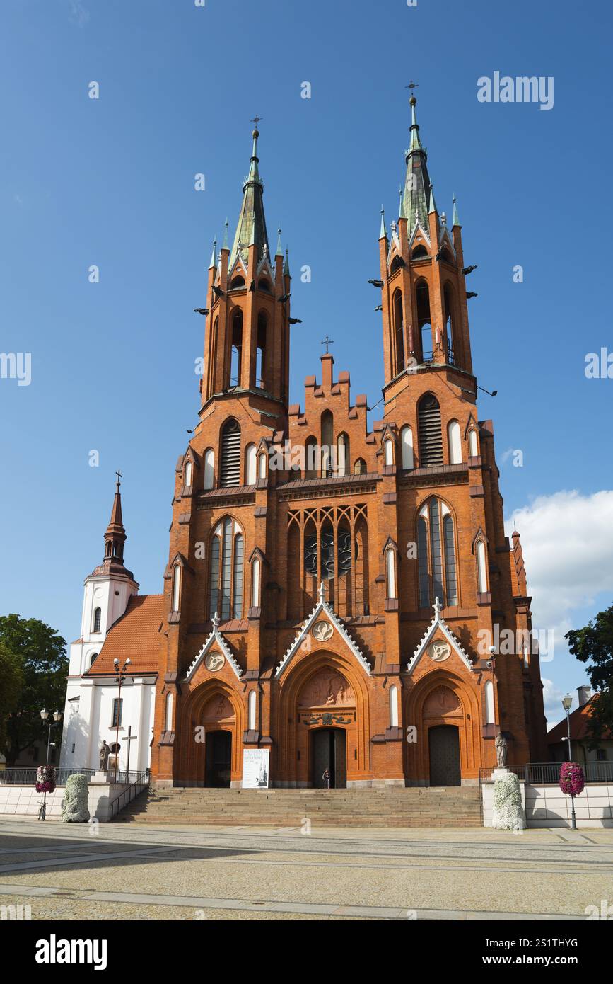 Large, red brick church with two high towers under a clear sky, Church ...