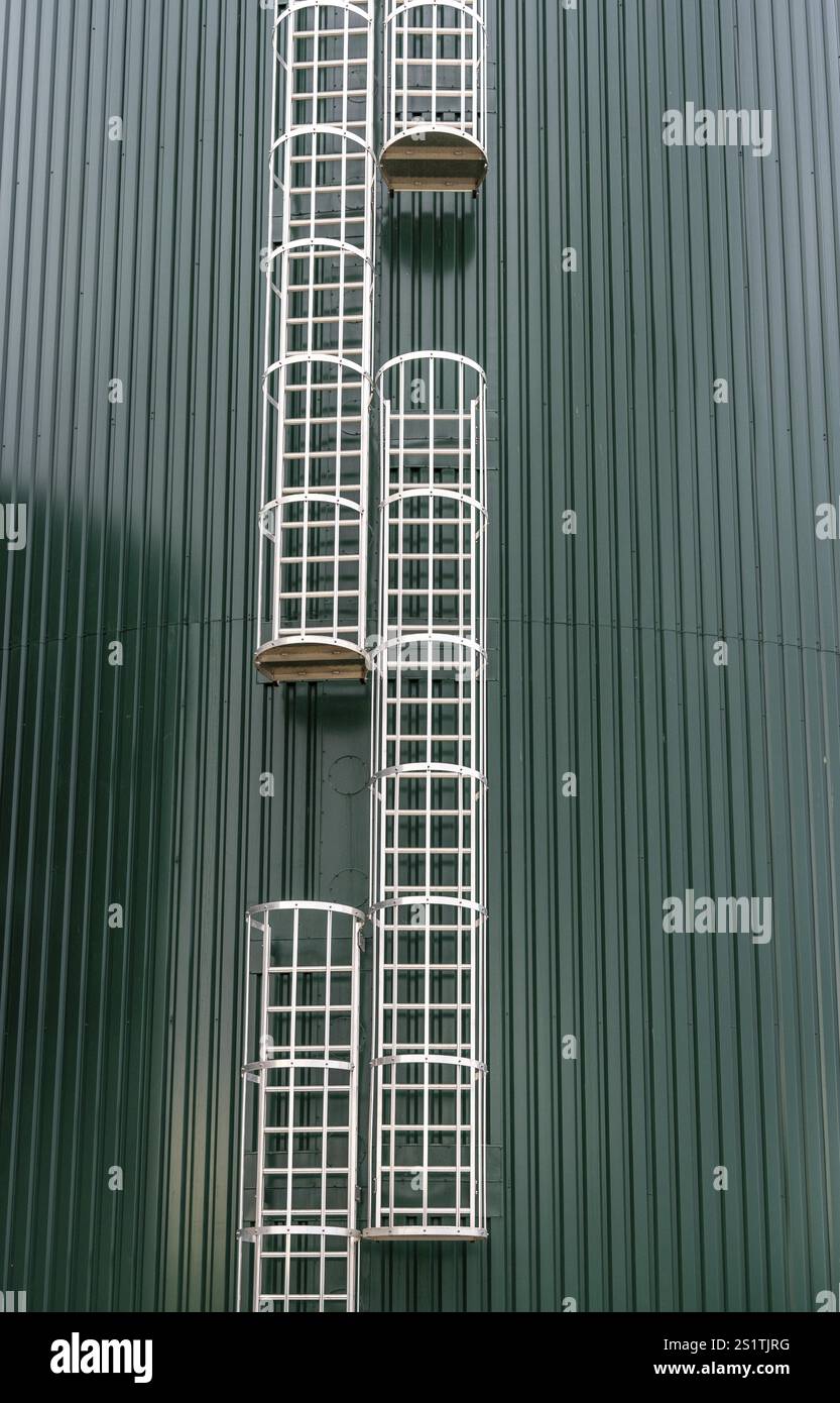 Fixed ladders with back protection on a technical building, climbing ...