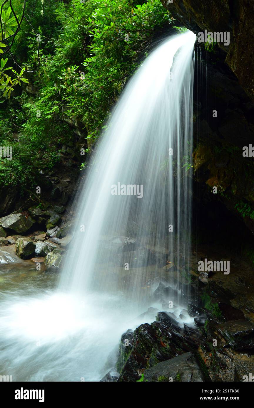 A hiking trail enables people to walk behind the cascading waterfall of ...