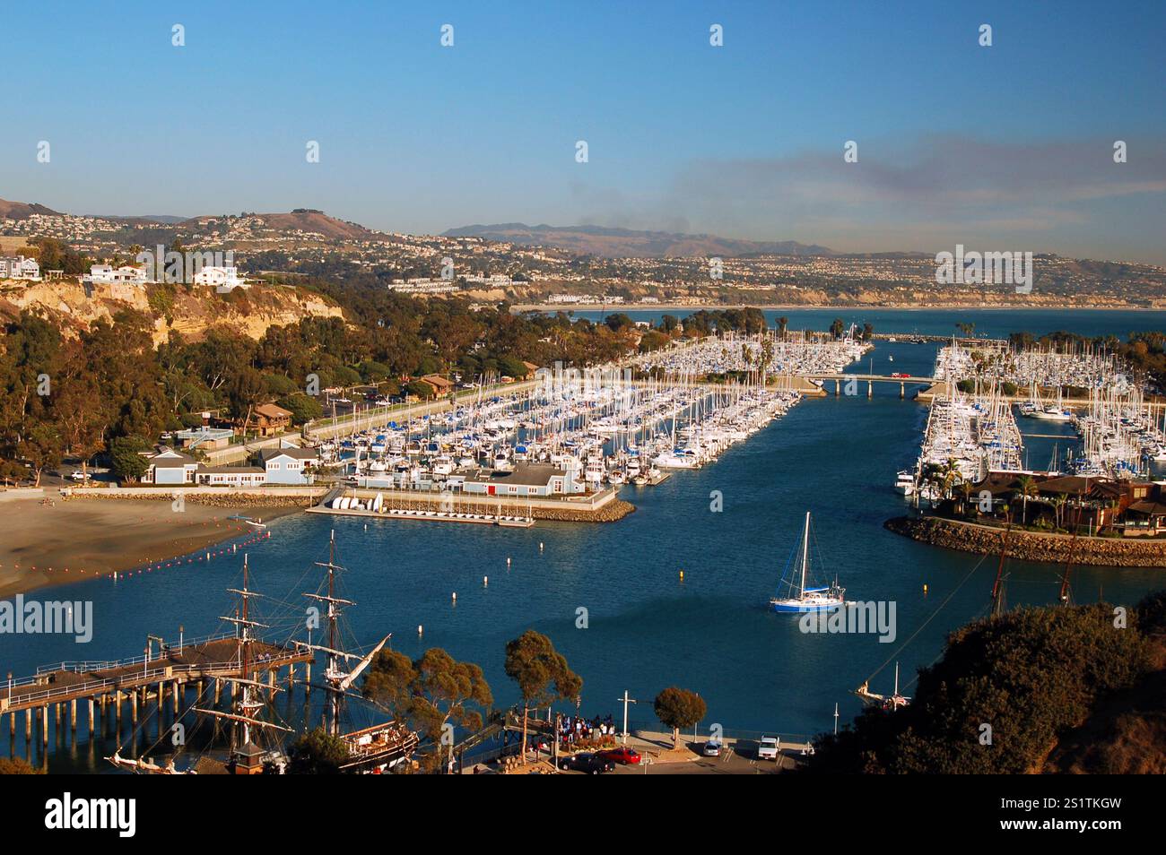 A high cliff gives an aerial view of the beautiful harbor and marina in ...