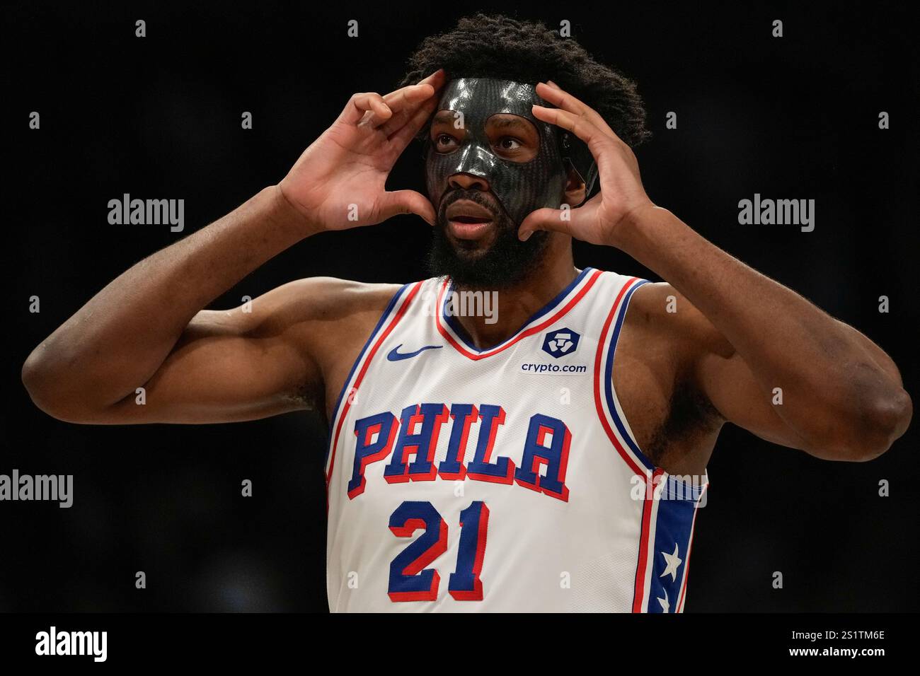 Philadelphia 76ers' Joel Embiid (21) adjusts his mask during the first ...