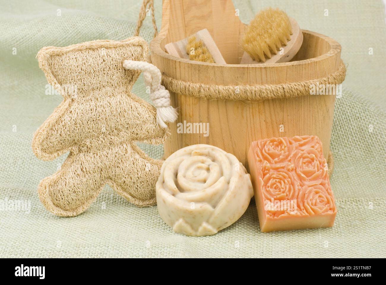 Natural spa accessories with loofah and handmade soaps in a wooden ...