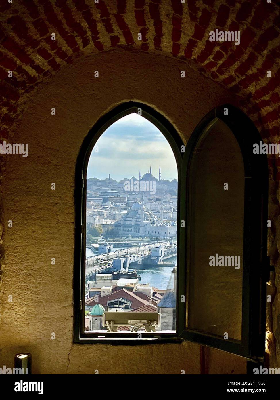 City view through an arched window, showcasing historic architecture ...