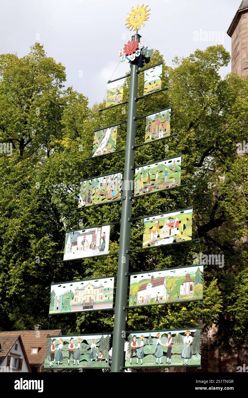 Large tree shaped signpost with pictures connected to sides and yellow ...