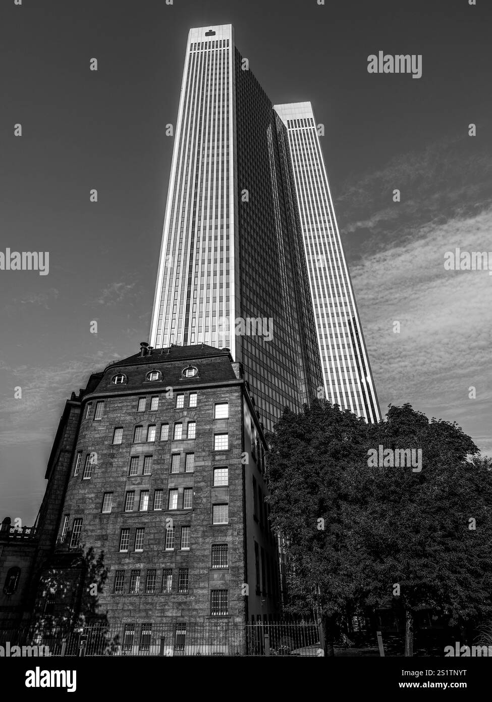 Impressively tall brick and glass building under a slightly cloudy sky ...