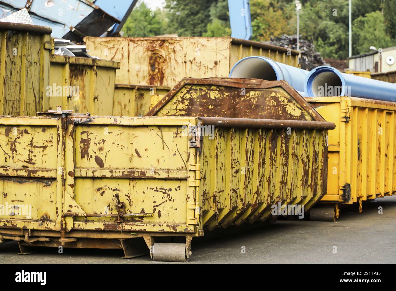 Used containers in a scrap yard Stock Photo - Alamy