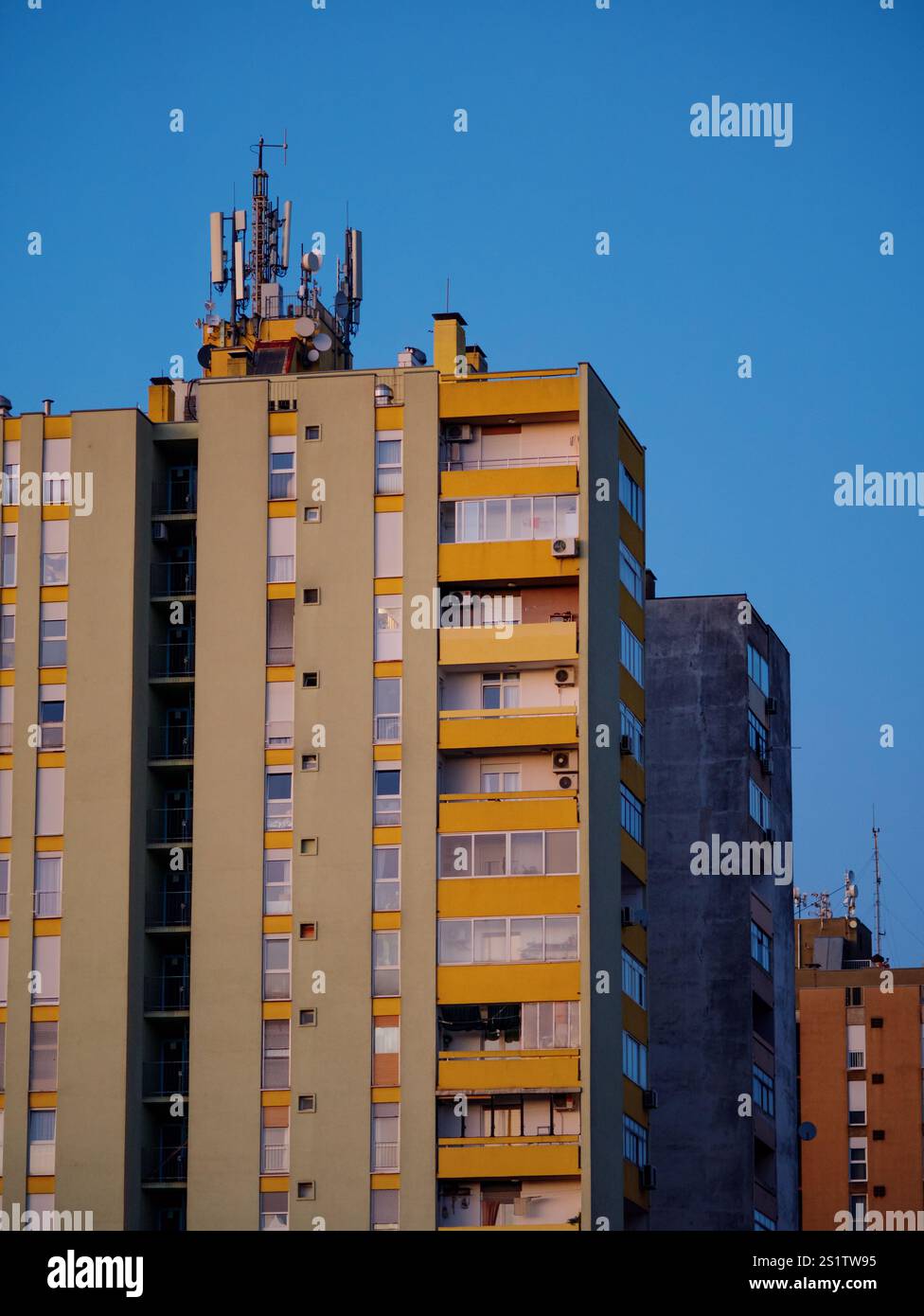Cellular antennas and transmitters on roof of residential building. Radio transmitting equipment ...