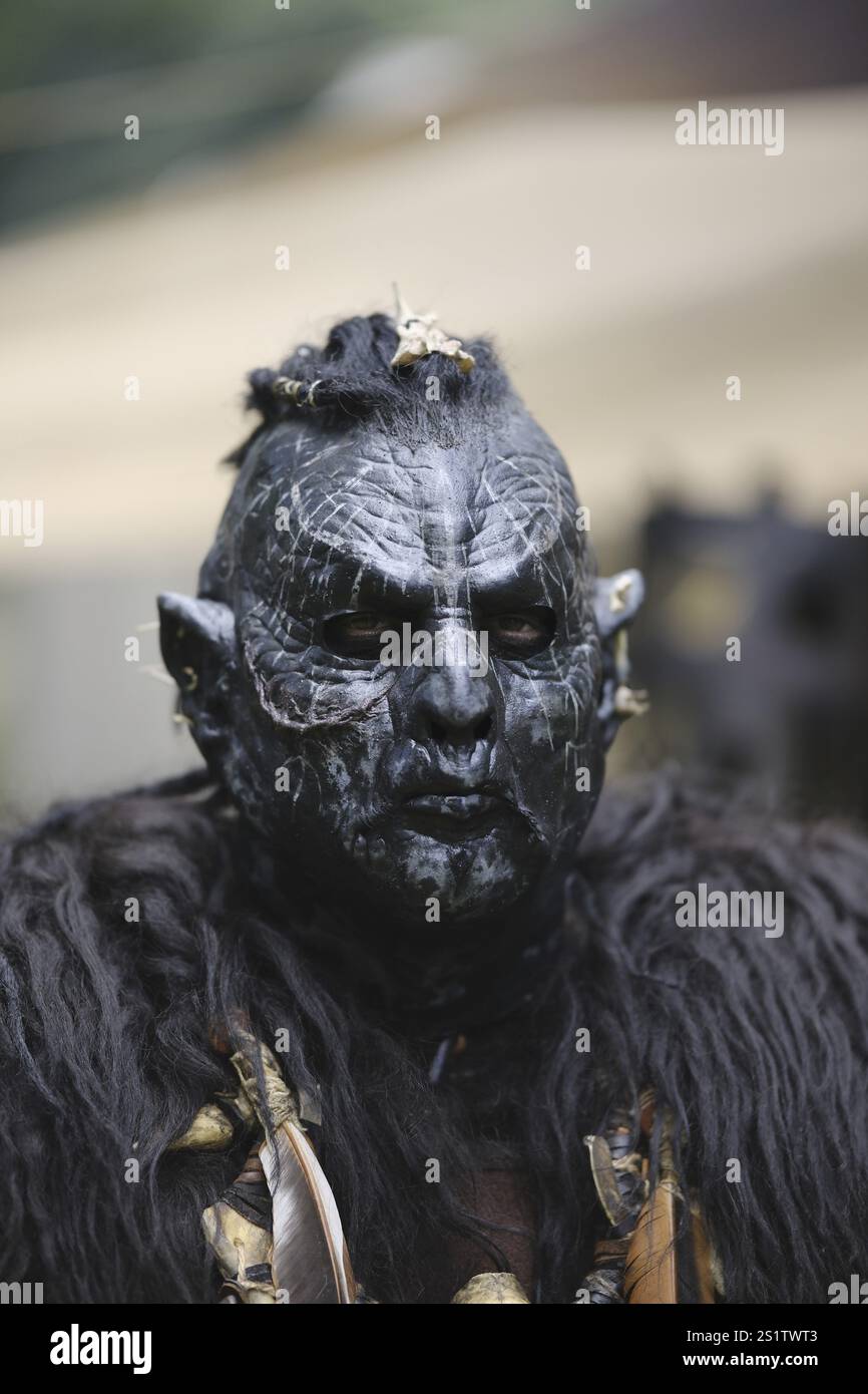Person with dark war paint and mask-like face Stock Photo - Alamy