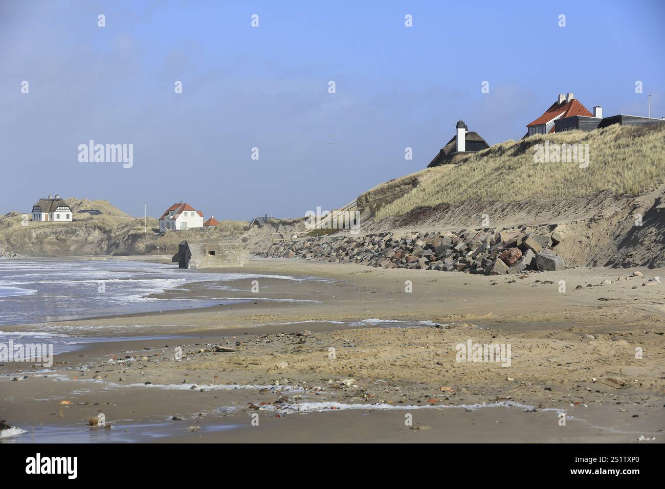 Beach with crashed bunkers of the German Wehrmacht and houses on the ...