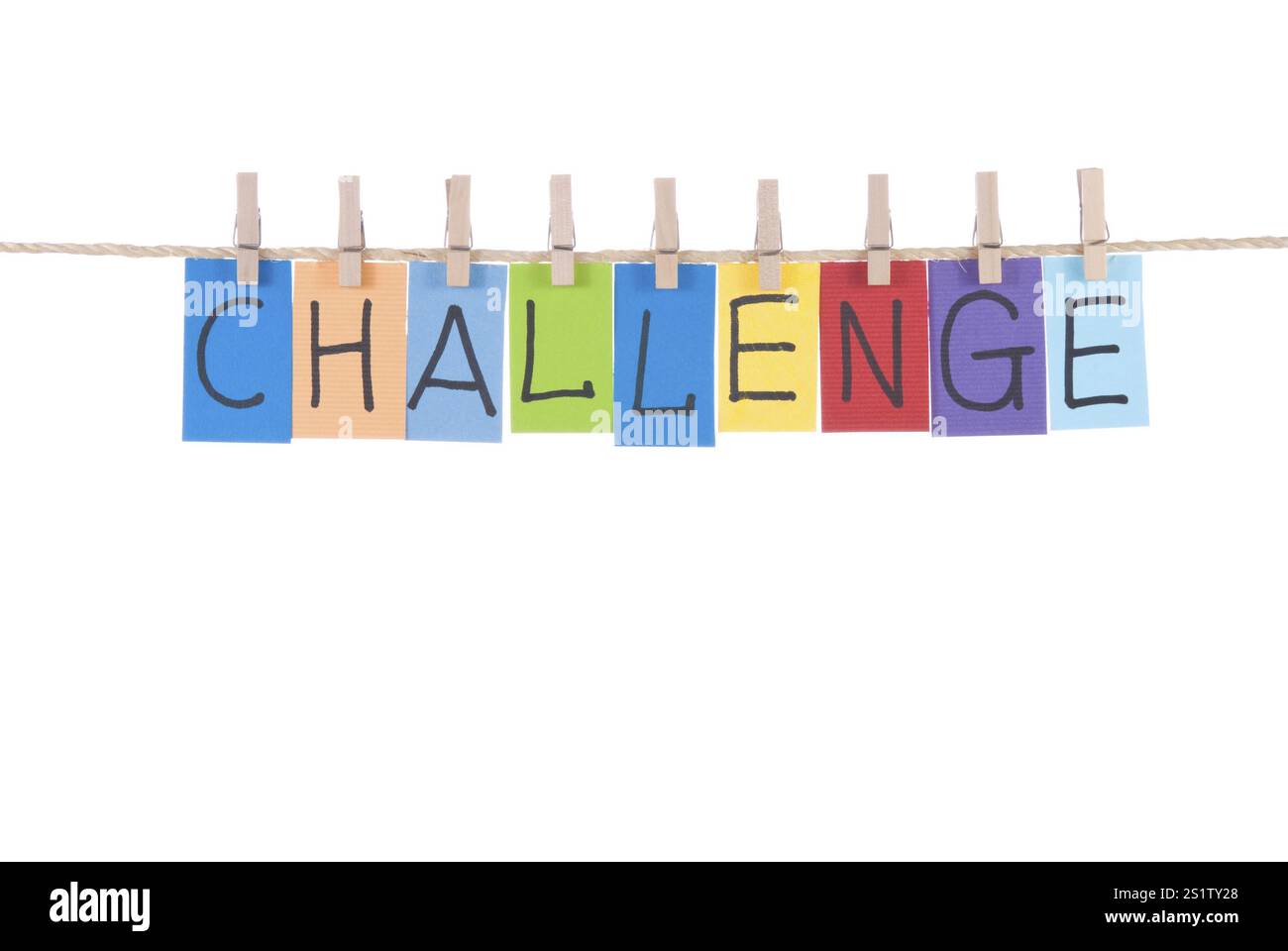 Colorful letters spelling challenge hung on a line with clothespins ...