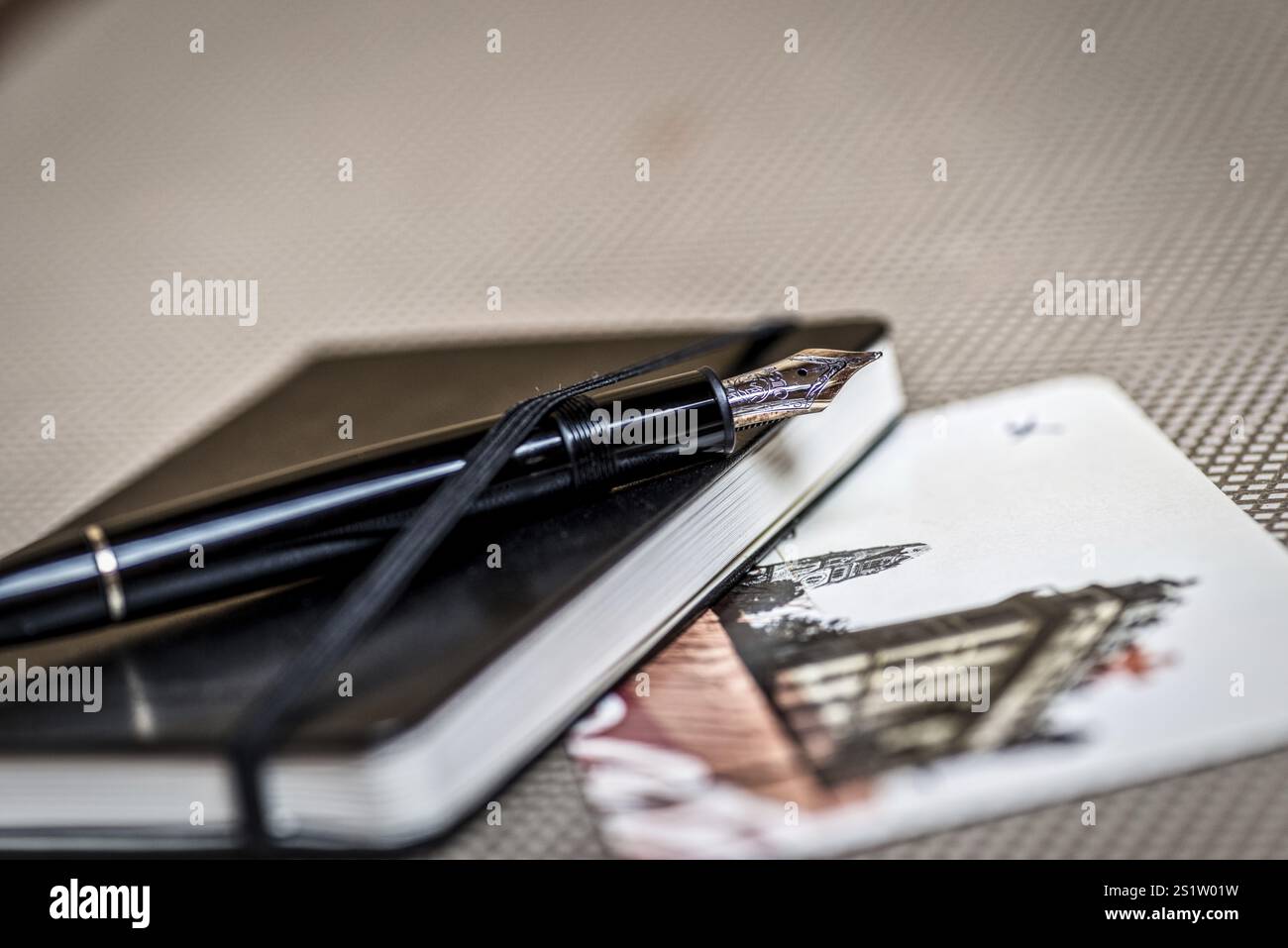 Still life with an old pen, memory book and a postcard in vintage style ...