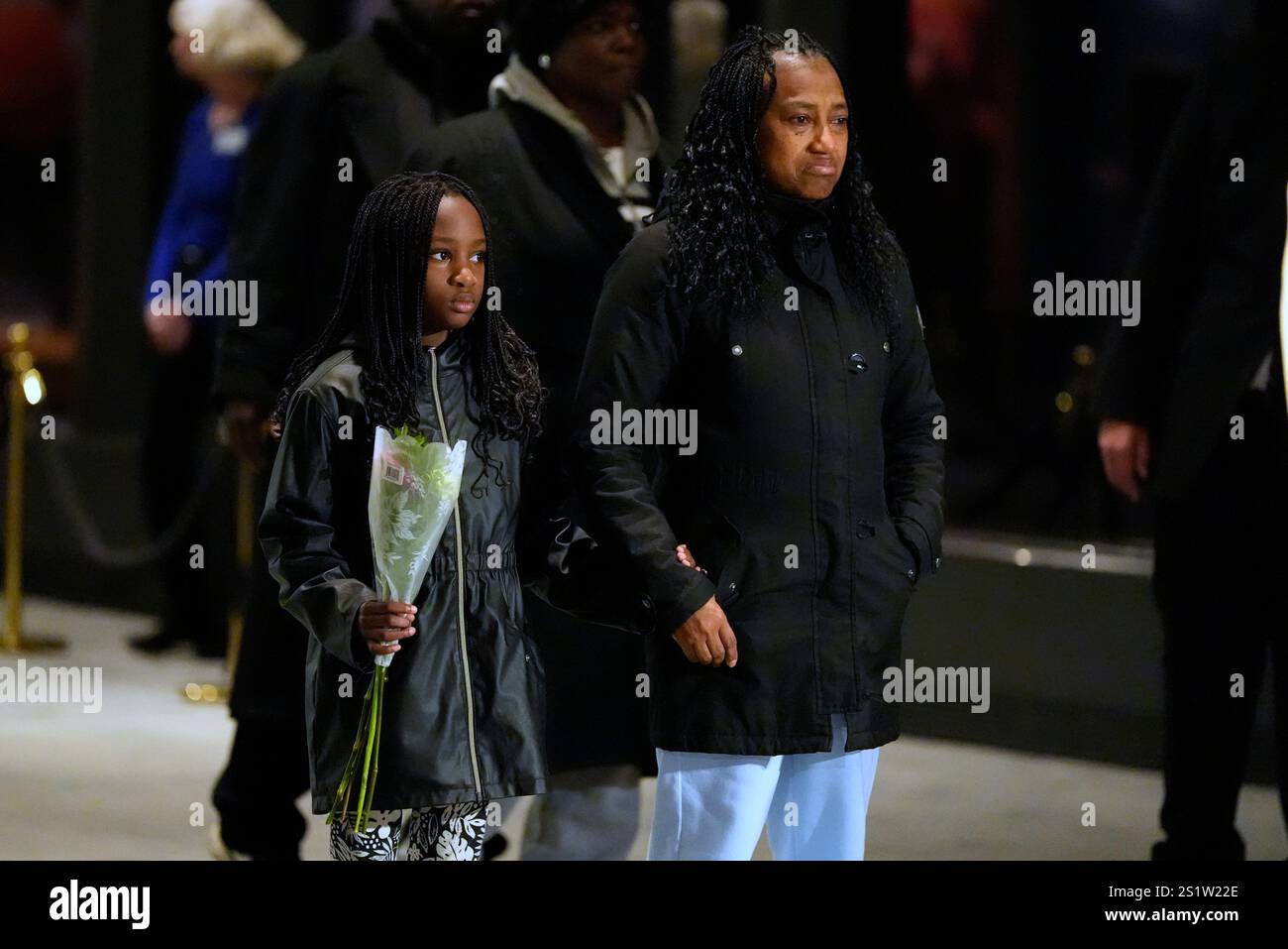 Mourners view the casket of former President Jimmy Carter as he lies in ...