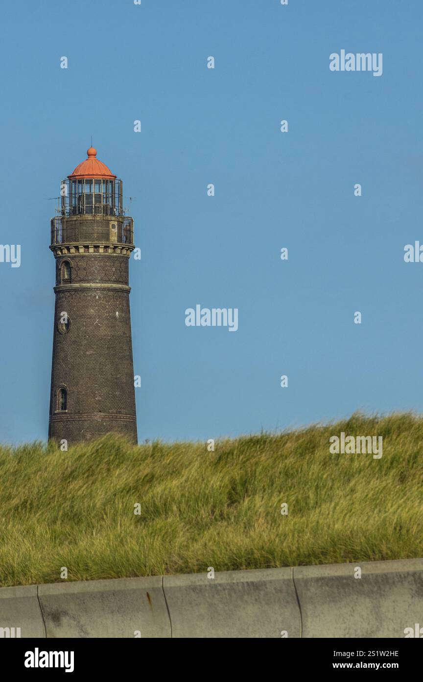 Lighthouse on the Isle of Borkum with blue sky and a dune in the ...