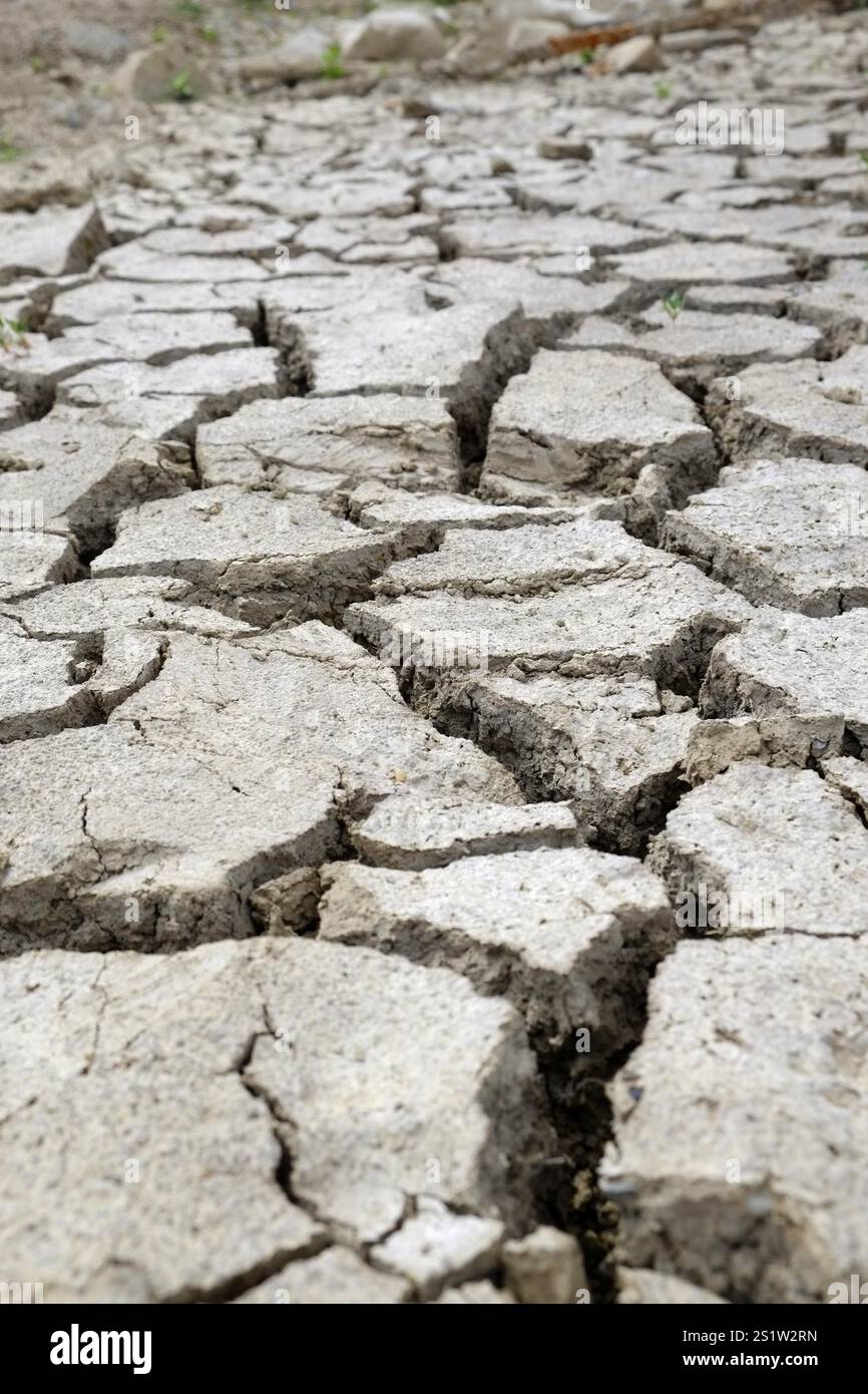 Earth burst open by prolonged drought with deep cracks and fissures ...