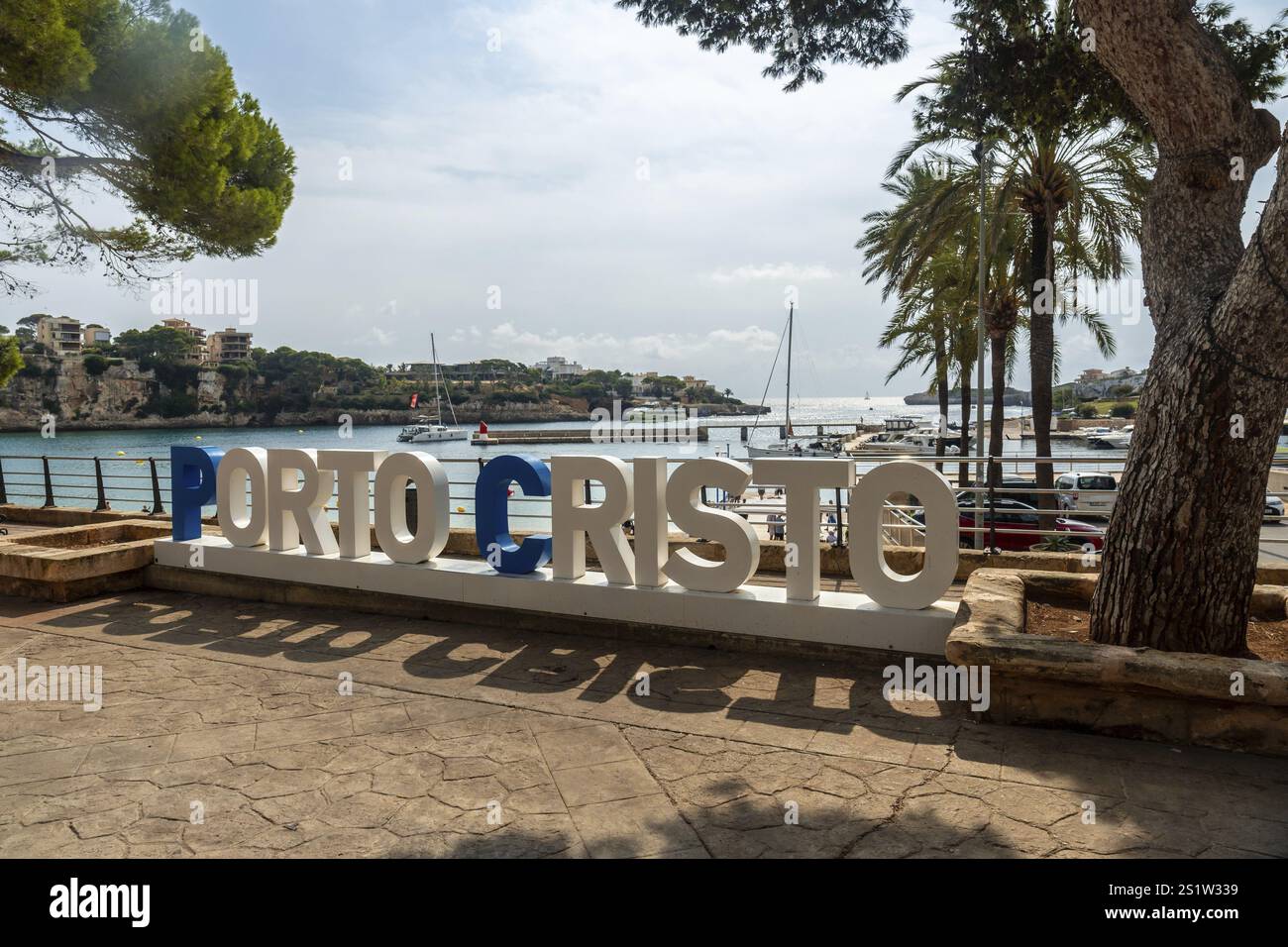 Large white and blue letters spelling porto cristo stand on a paved ...