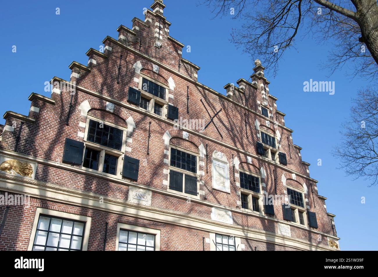 Traditional dutch gable with ornate brickwork and black shutters ...