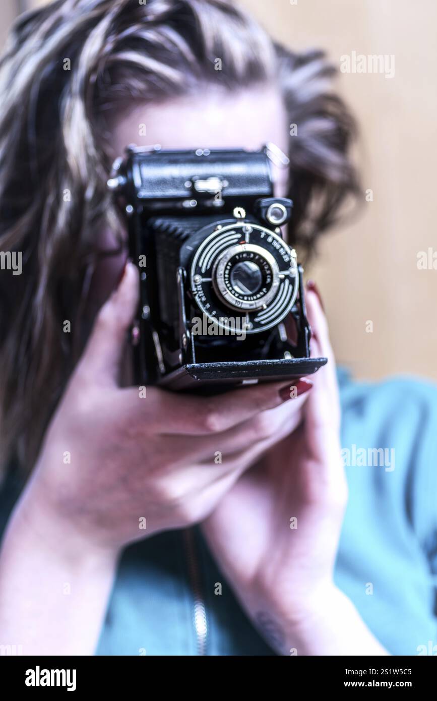 Old, historic, black camera with manual setting and concertina lens ...