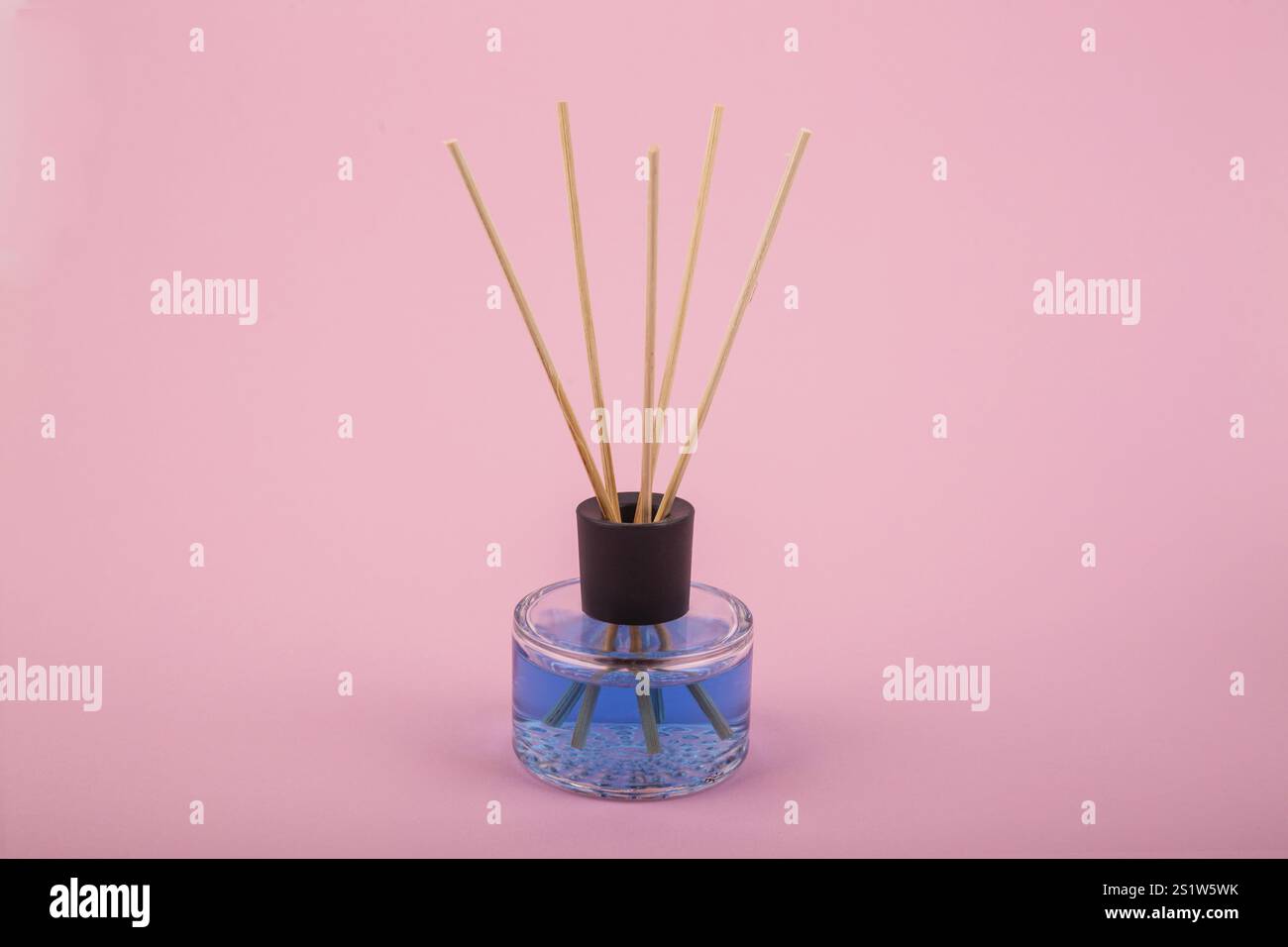 Scent sticks in the glass on the pink background Stock Photo - Alamy