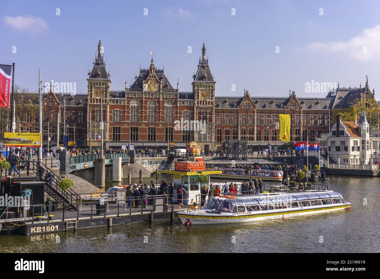 The city of Amsterdam in springtime with houses and water is a famous ...