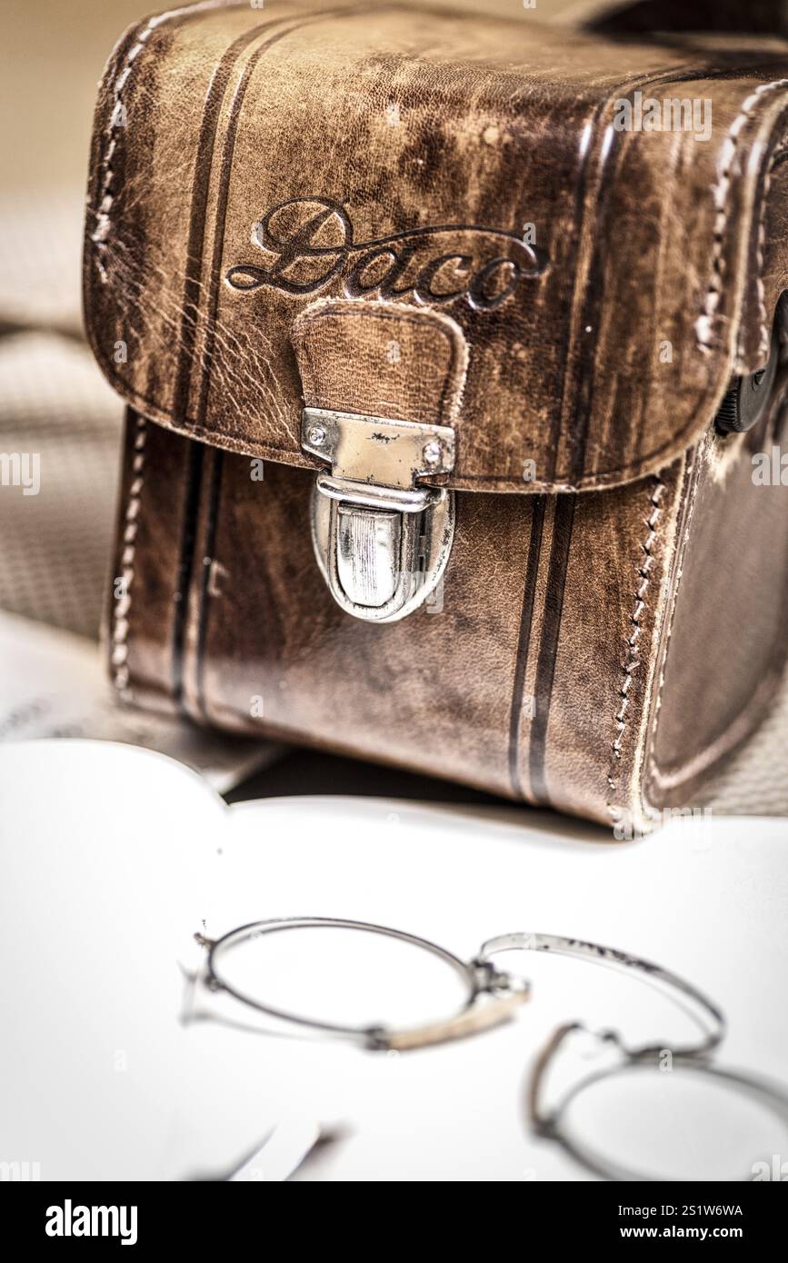 Still life with an old camera, glasses and a memory book in vintage ...