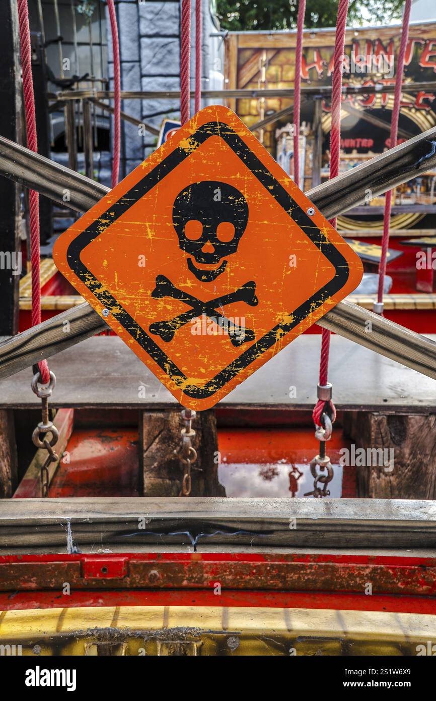 Hanging metal sign toxic with scull and bones over orange Stock Photo ...