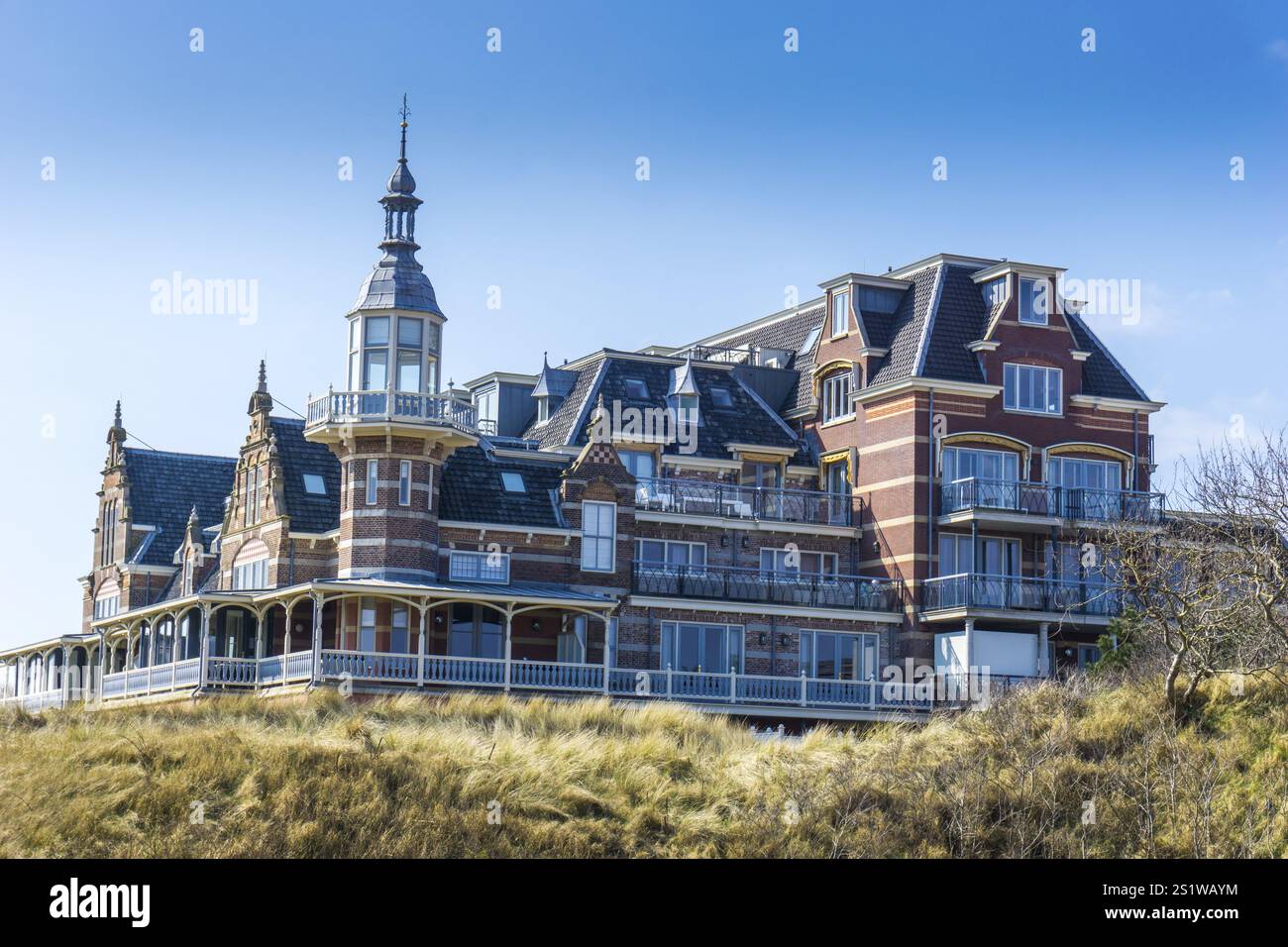 Beautiful building with little towers at the dunes at the seaside, like ...