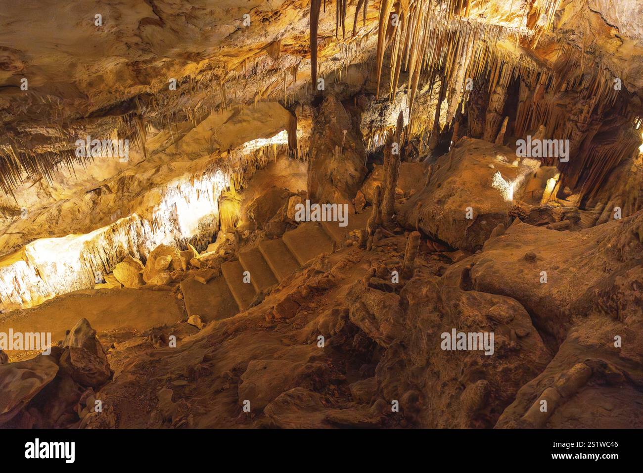 Geological formations of stalactites and stalagmites create a ...