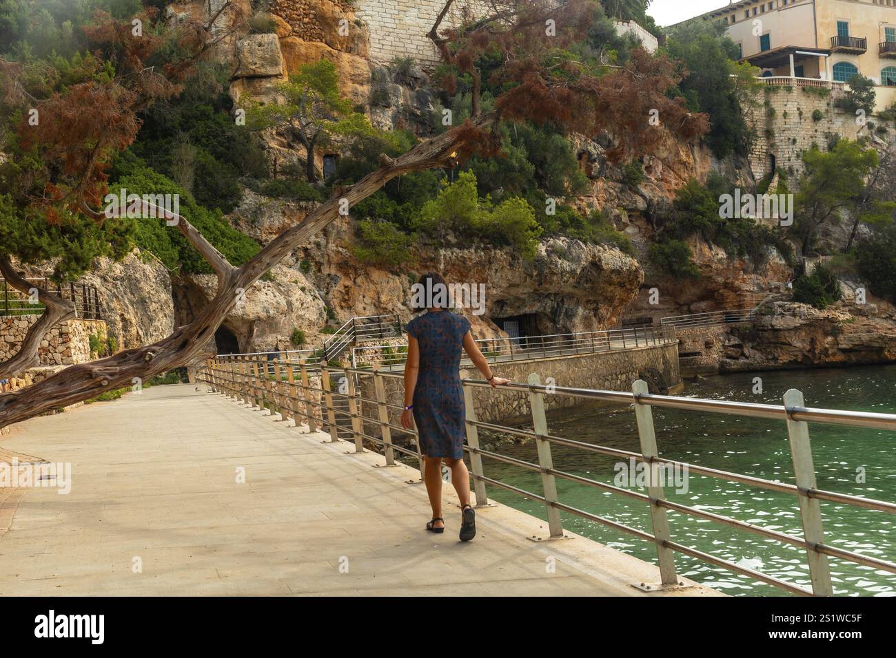 Tourist enjoying a walk on the promenade by the sea in puerto cristo ...