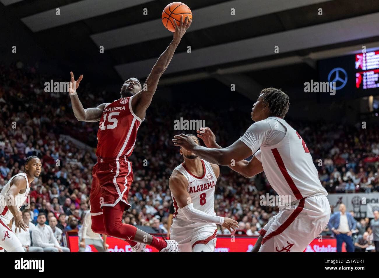 Oklahoma guard Duke Miles (15) shoots past Alabama guard Chris ...