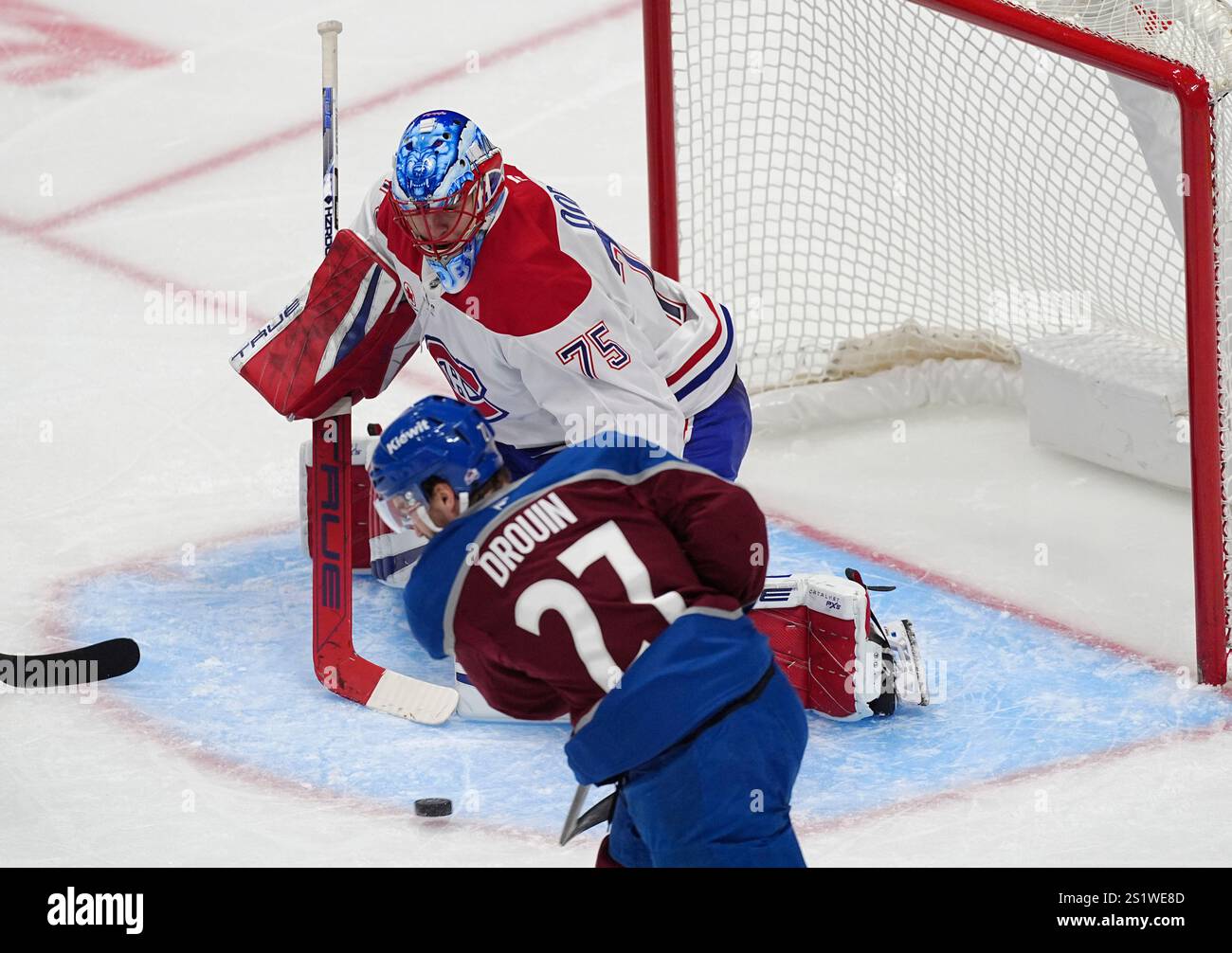 Colorado Avalanche left wing Jonathan Drouin, front, puts a shot on ...