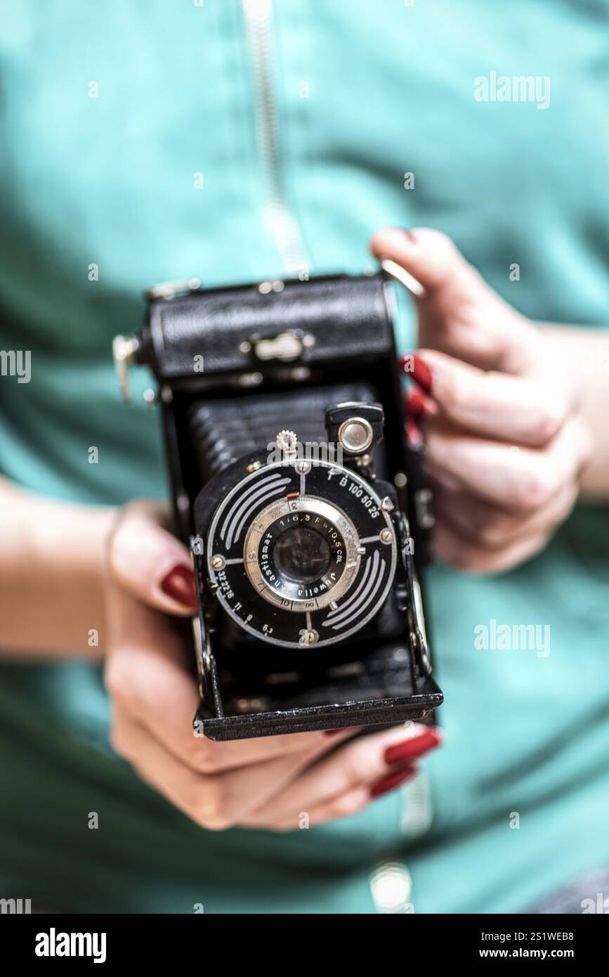 Old, historic, black camera with manual setting and concertina lens ...