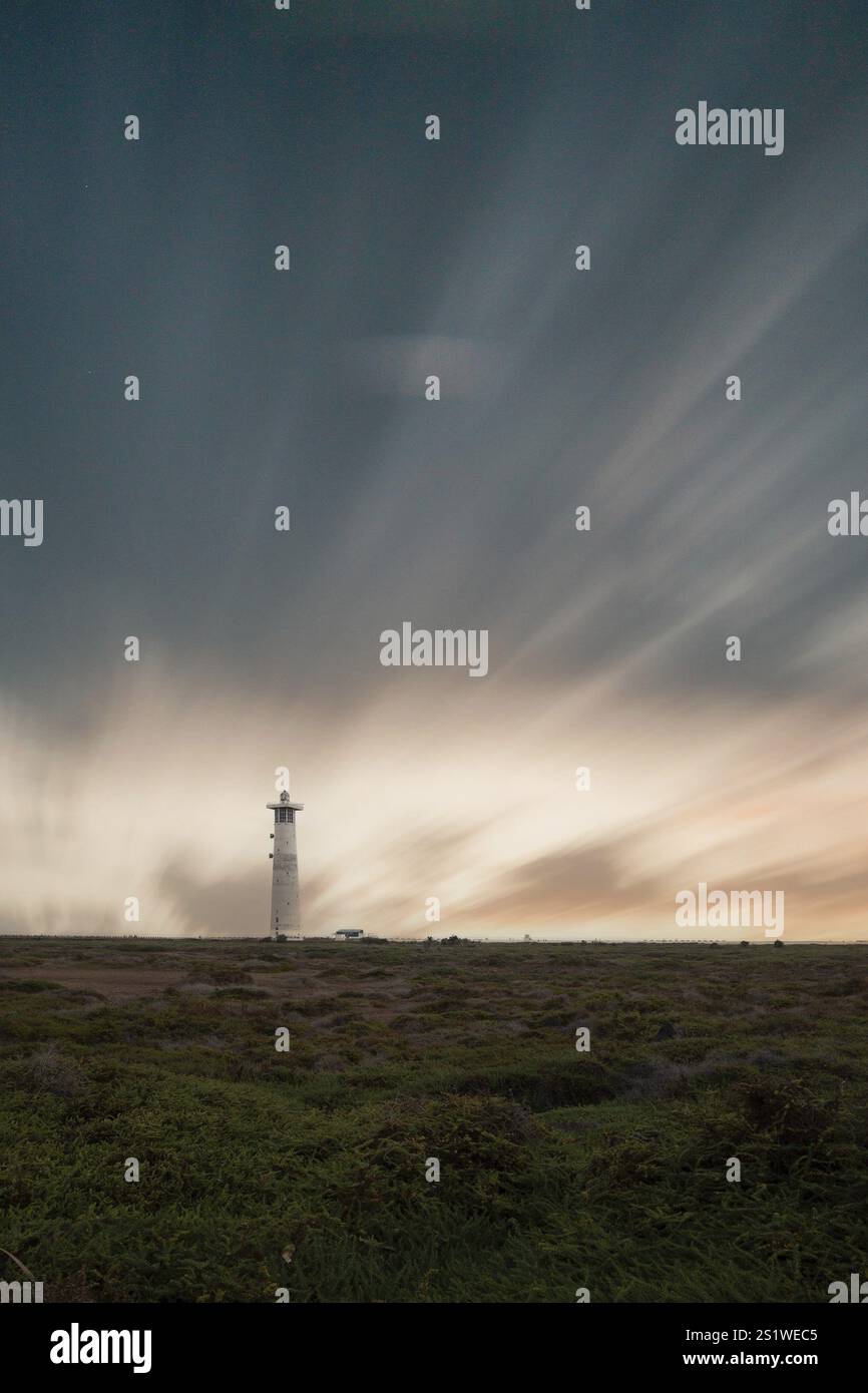 Dusk, landscape shot with lighthouse in nature reserve. View of the sea ...
