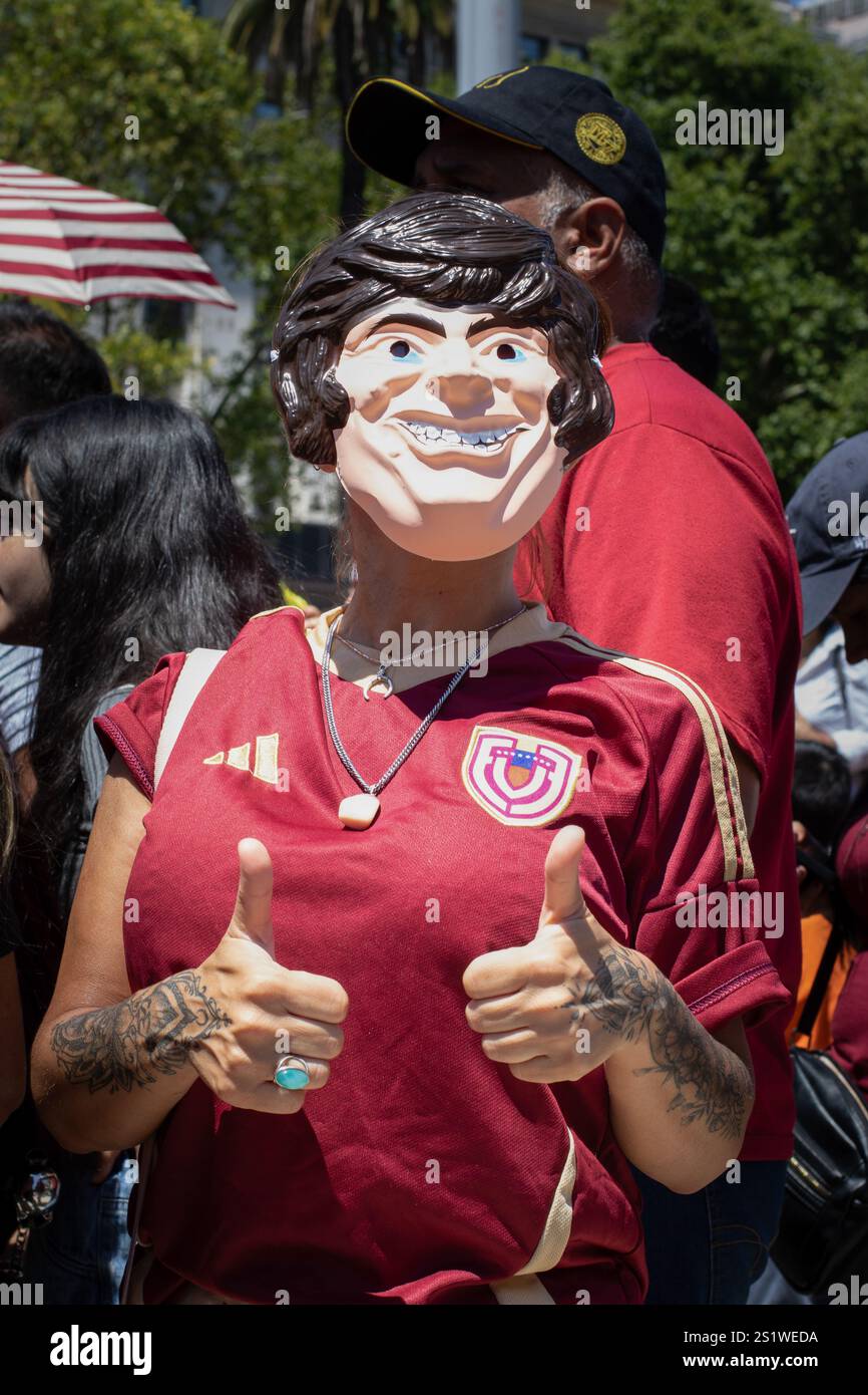 A woman wearing a shirt from the Venezuelan soccer team and a mask of ...