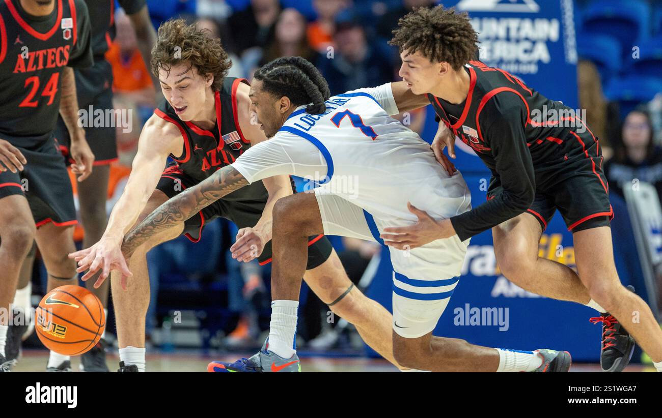 Boise State's Chris Lockett Jr., center, fights for control of the ball ...