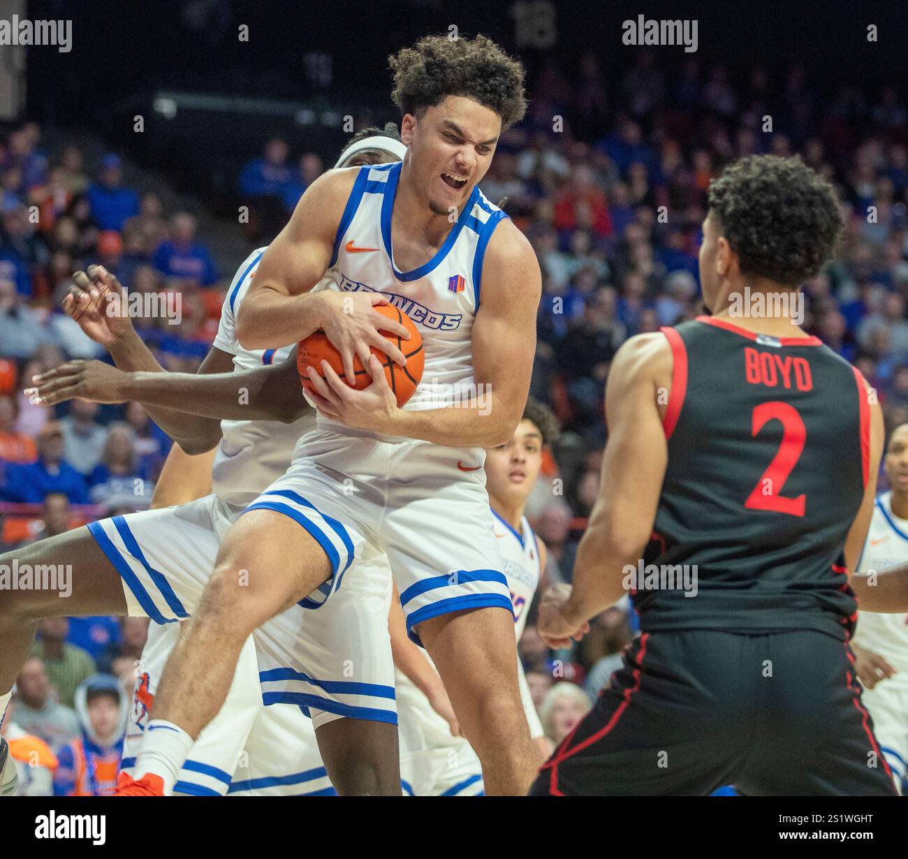 Boise State's Javan Buchanan, front left, grabs a rebound over San ...
