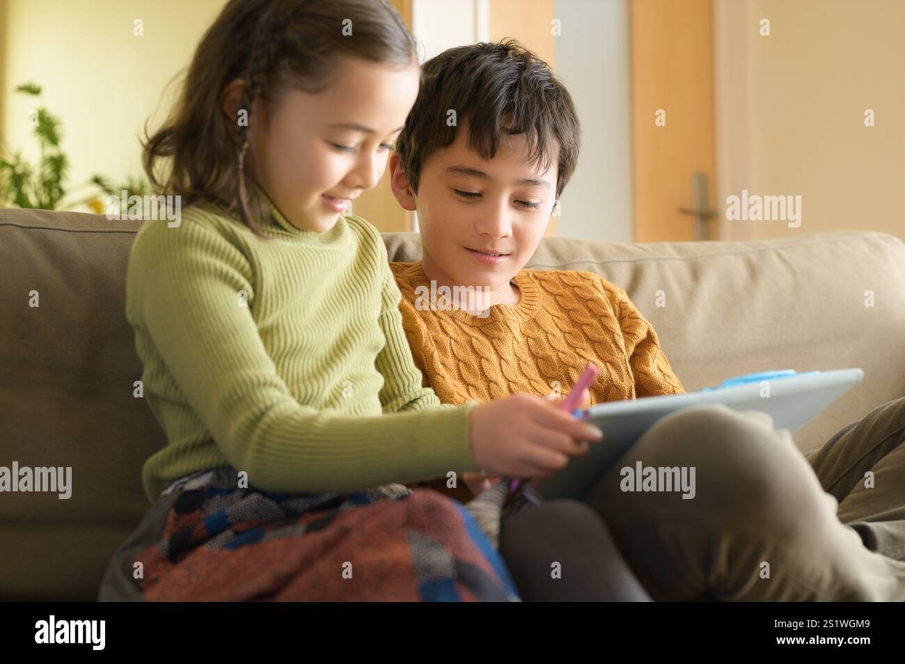 Two Kids Studying at Home with a Tablet Stock Photo - Alamy