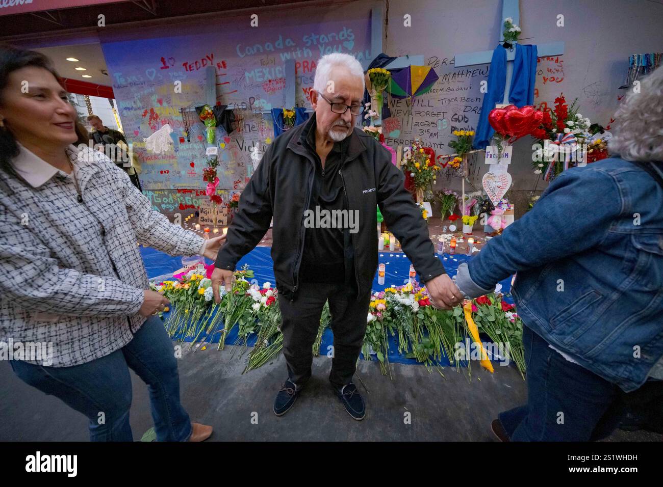 Long Island, New York residents Louis Tenedorio holds hands with family ...