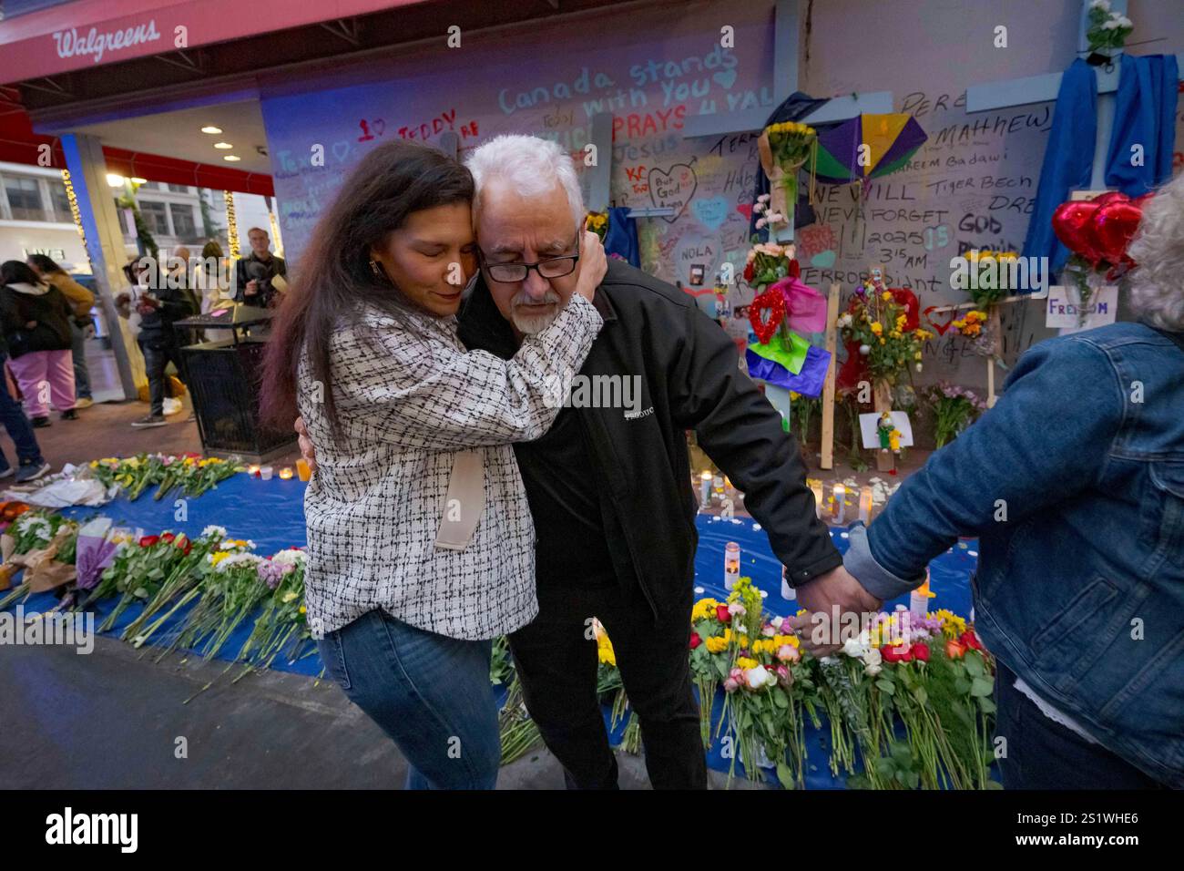 Long Island, New York residents Louis Tenedorio is hugged by family ...