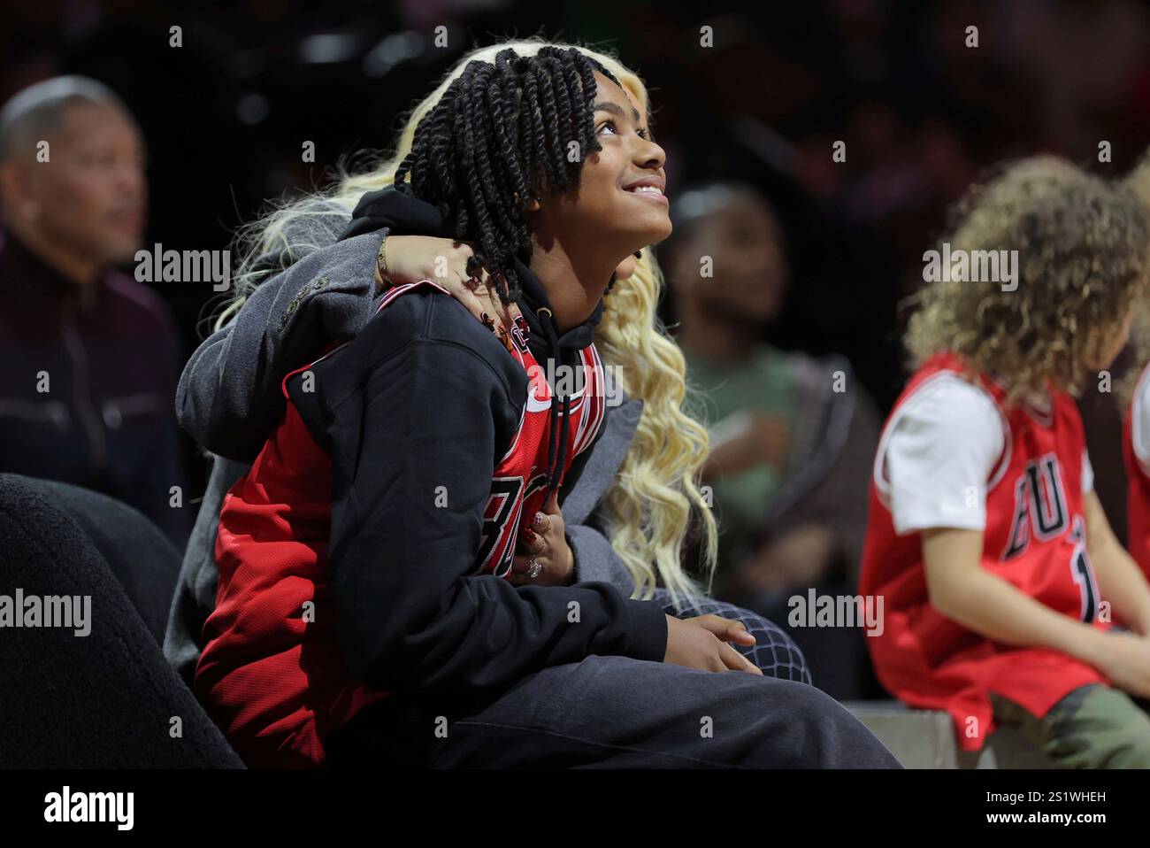 Former NBA player Derrick Rose's son PJ Rose watches the Jumbotron ...