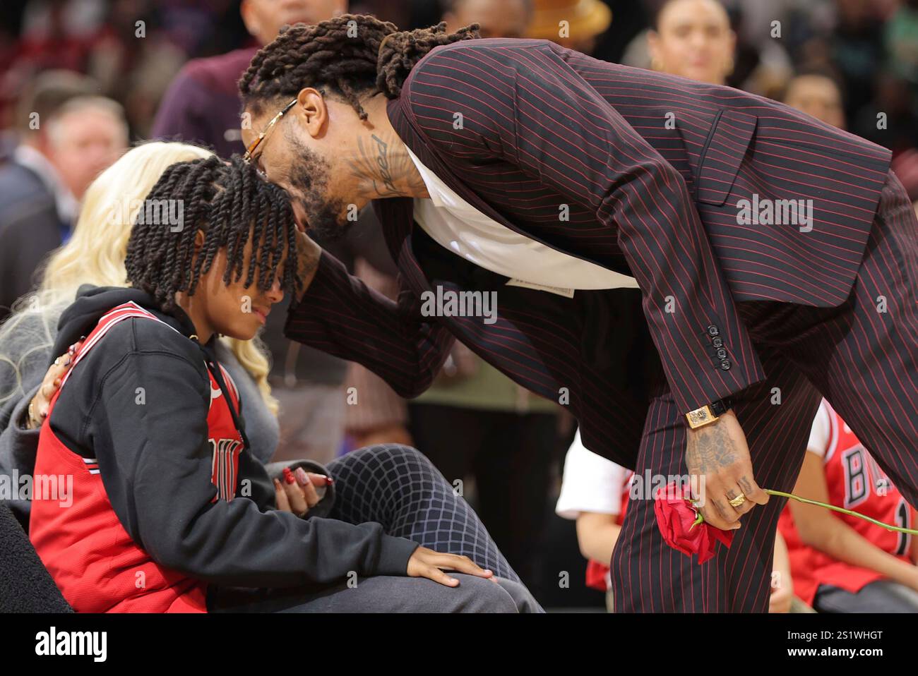 Former NBA player Derrick Rose, right, kisses his son PJ Rose, left ...